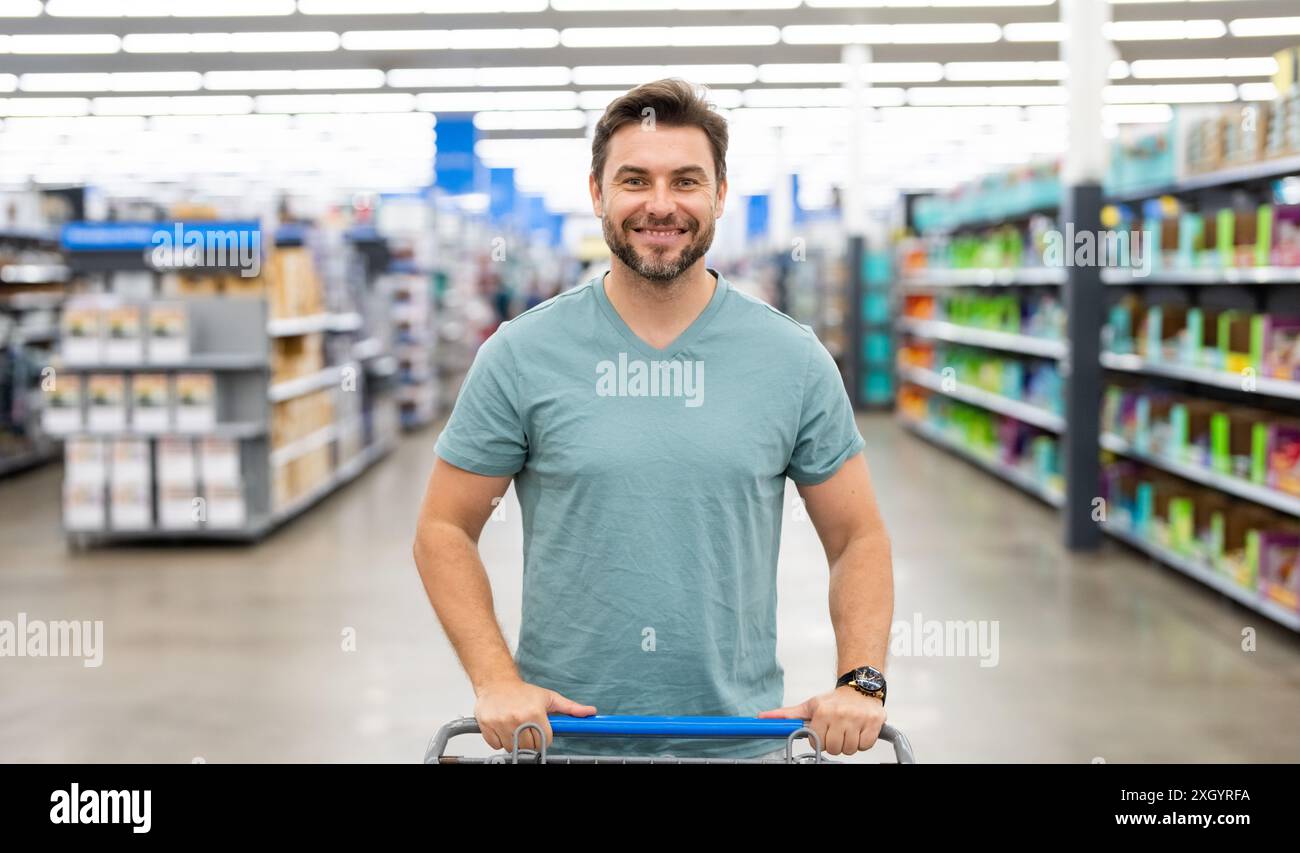 Happy Man shopper with shopping cart. Good purchases. Man purchases in ...