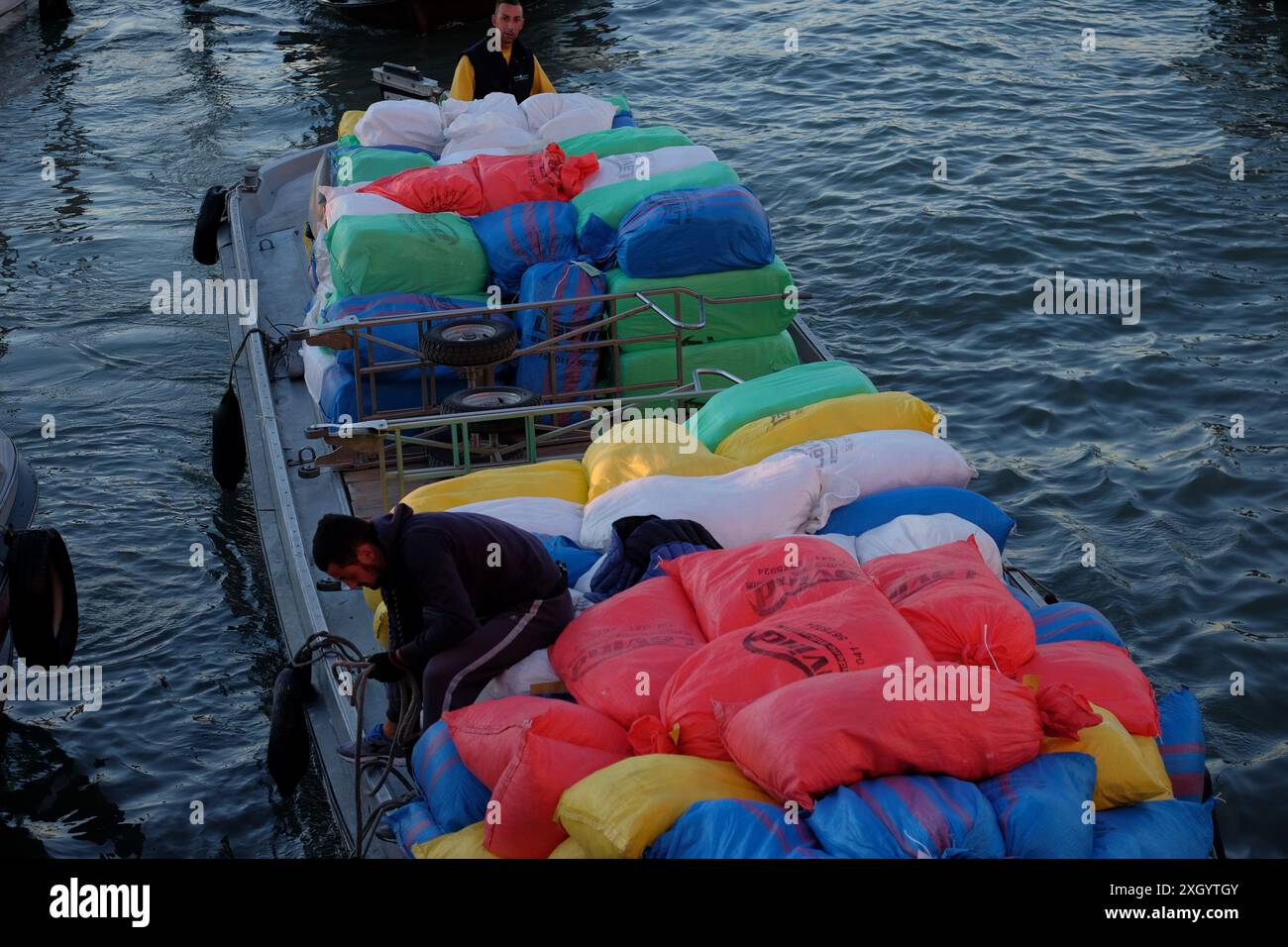 A delivery boat brings laundry in colour coded bags to a mooring early ...
