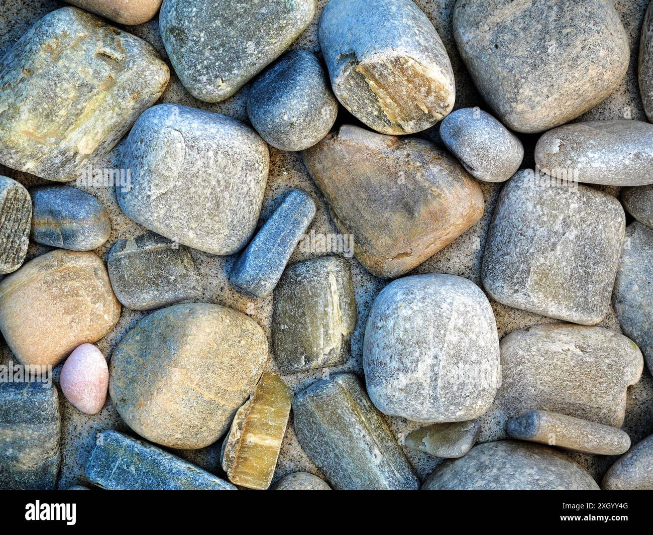 Baltic Sea jade raw stones – in beach sand, ideal as a texture. When ...