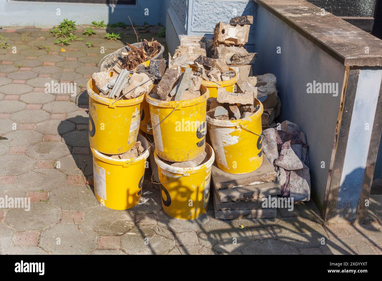 Yellow buckets filled with building rubble, Germany Stock Photo - Alamy
