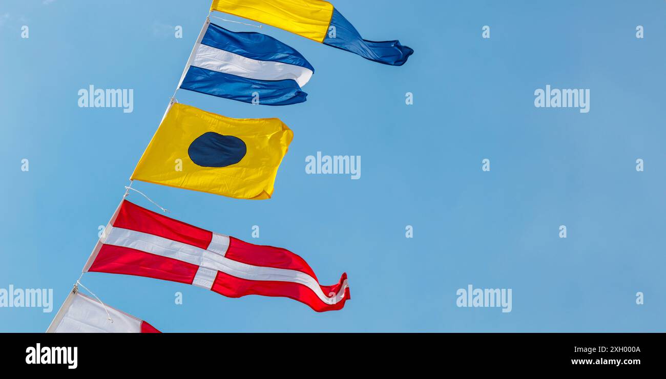 International maritime signal flags on a flagpole and masts on a ...