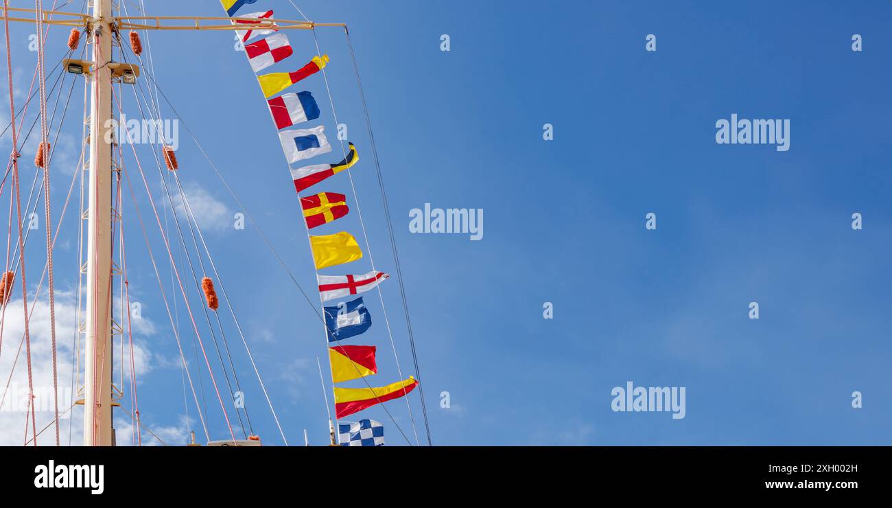 International maritime signal flags on a flagpole and masts on a ...