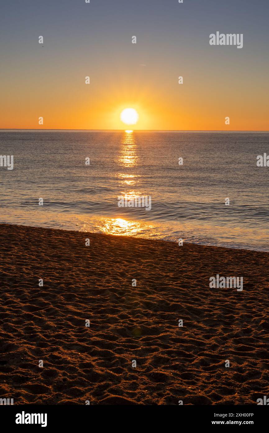 The first rays of the sun gently touch the horizon, illuminating the ...