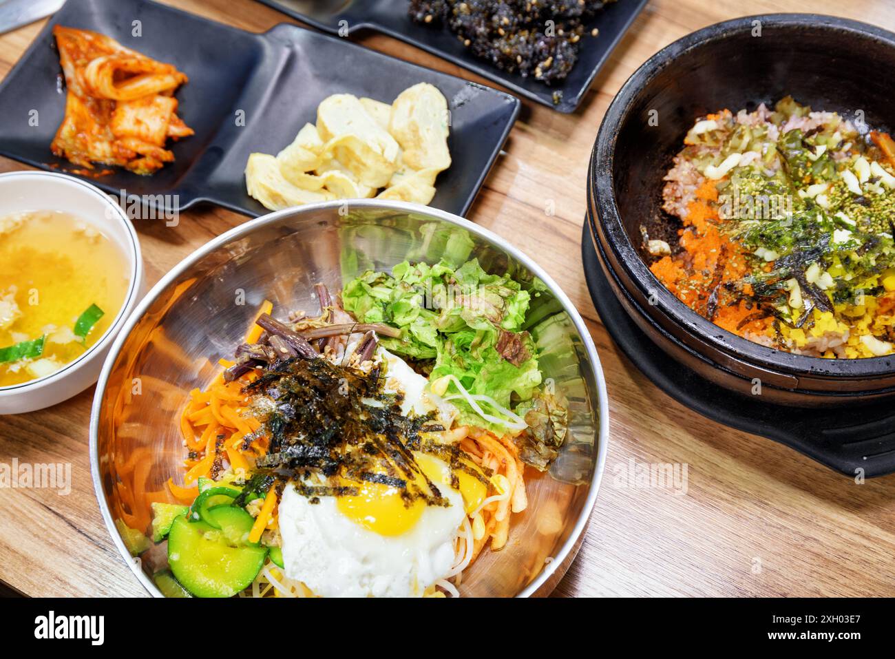 Bowl of hot Bibimbap. Mixed rice with meat, fried egg and assorted ...