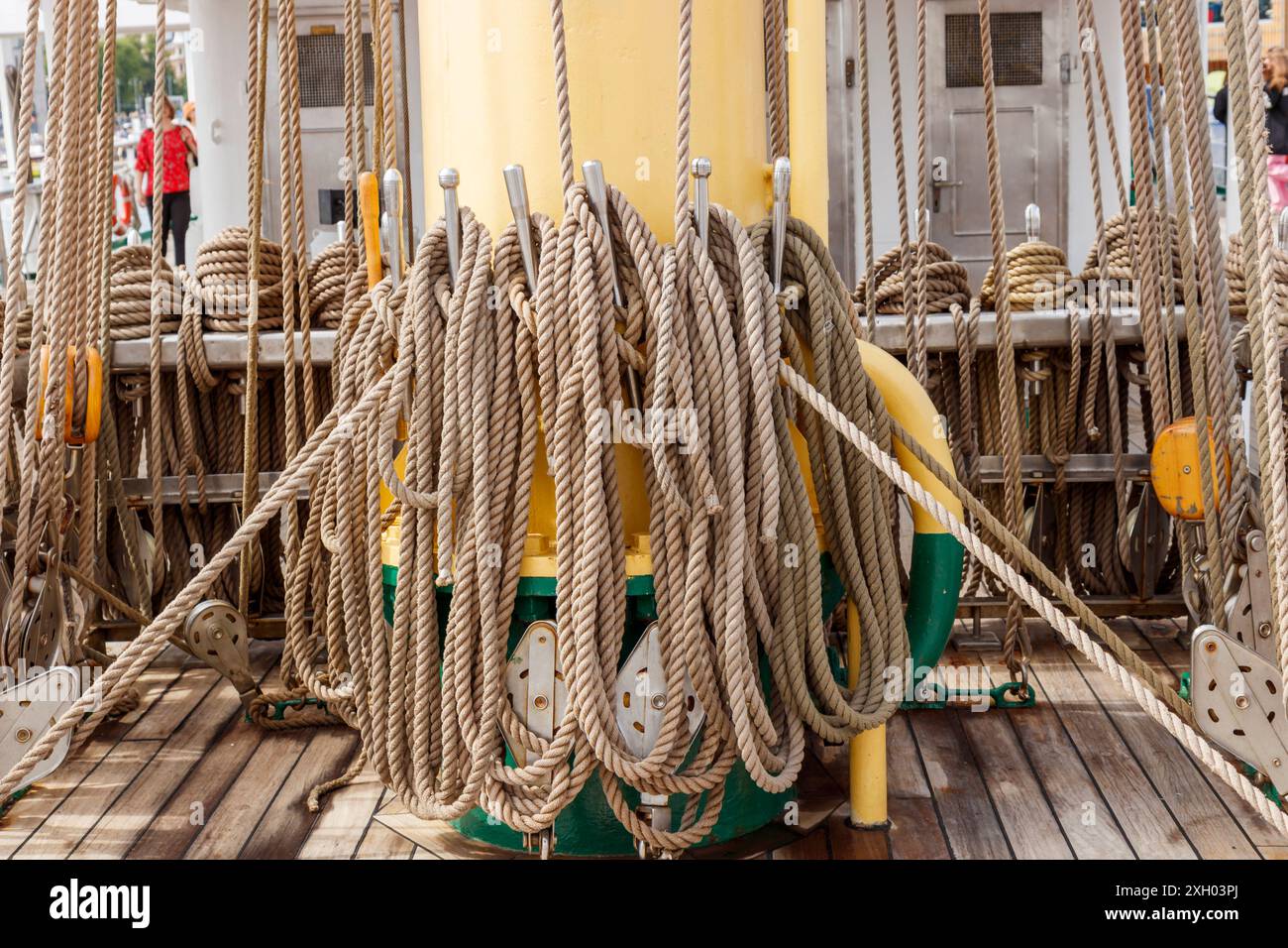 Neatly coiled ropes on the deck of a traditional sailing ship, resting ...