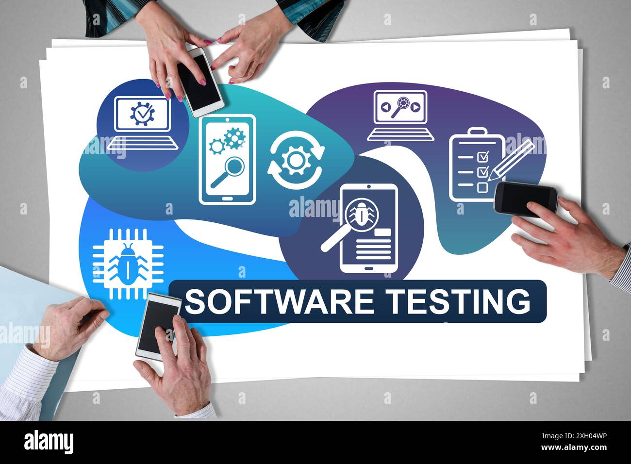 Software testing concept placed on a desk with hands using smartphones ...