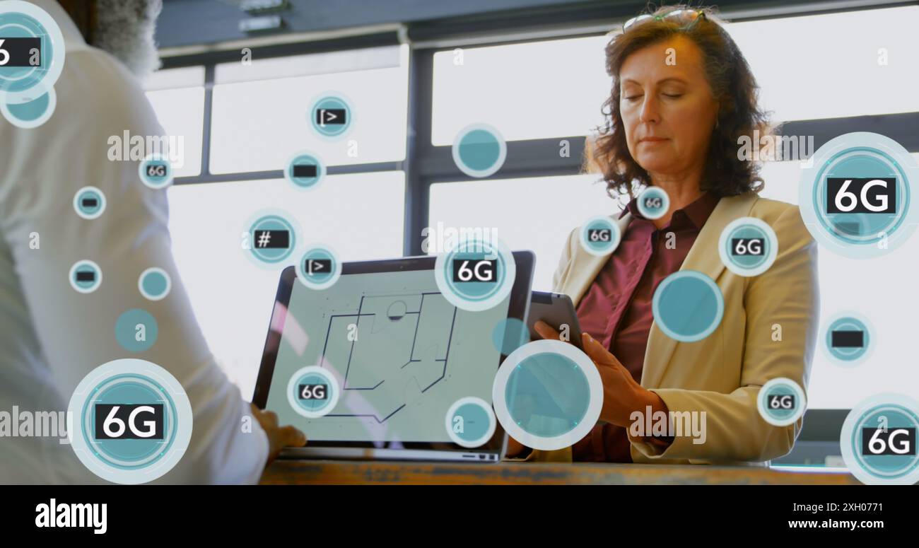 Image of multiple 6g text in circles over diverse coworkers using laptop and cellphone in office ...