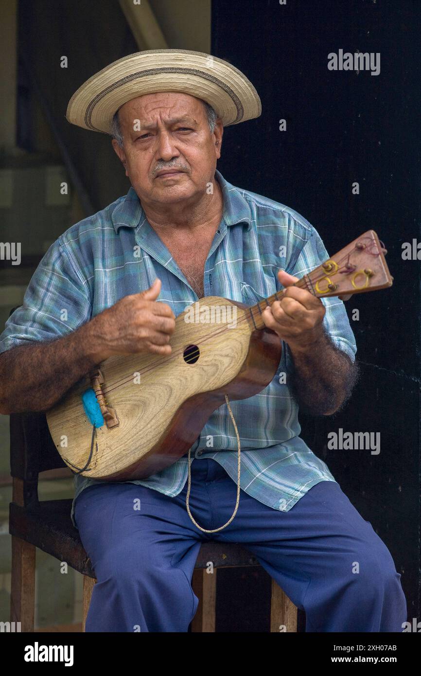 Panama, Los Santos. Man is playing the traditional guitar of the ...