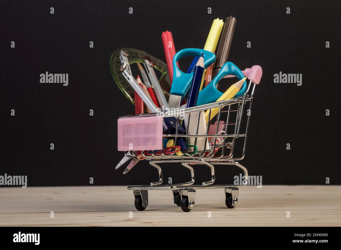 back to school template with multiple stationery in trolley with copy ...