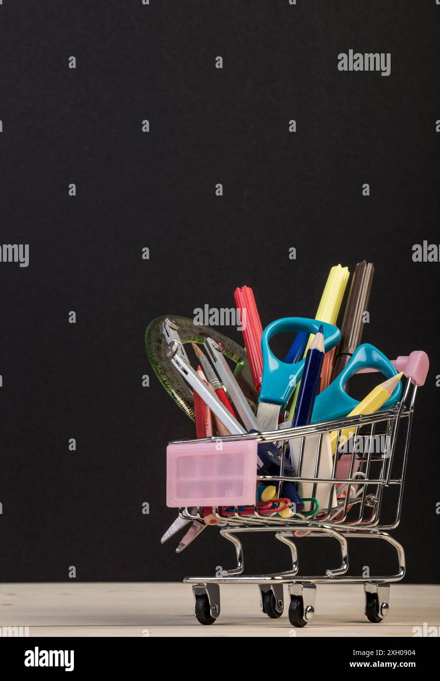 back to school template with multiple stationery in trolley with copy ...