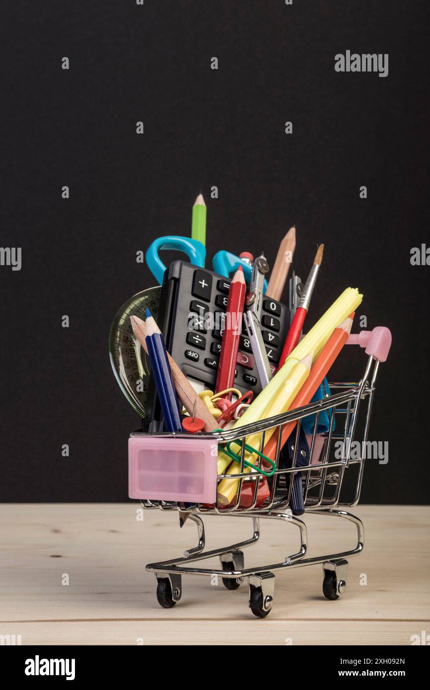 back to school template with multiple stationery in trolley with copy ...