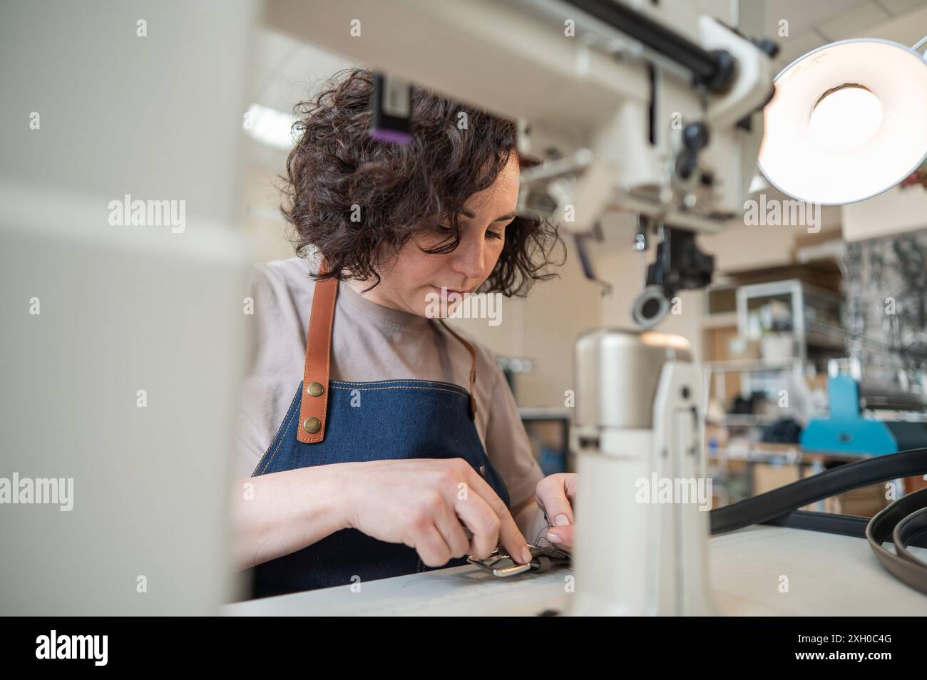 Woman sewing machine sews leather hi-res stock photography and images ...