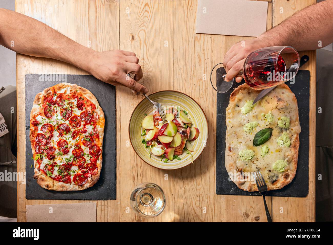 Around the table, several people are seated comfortably on wooden ...