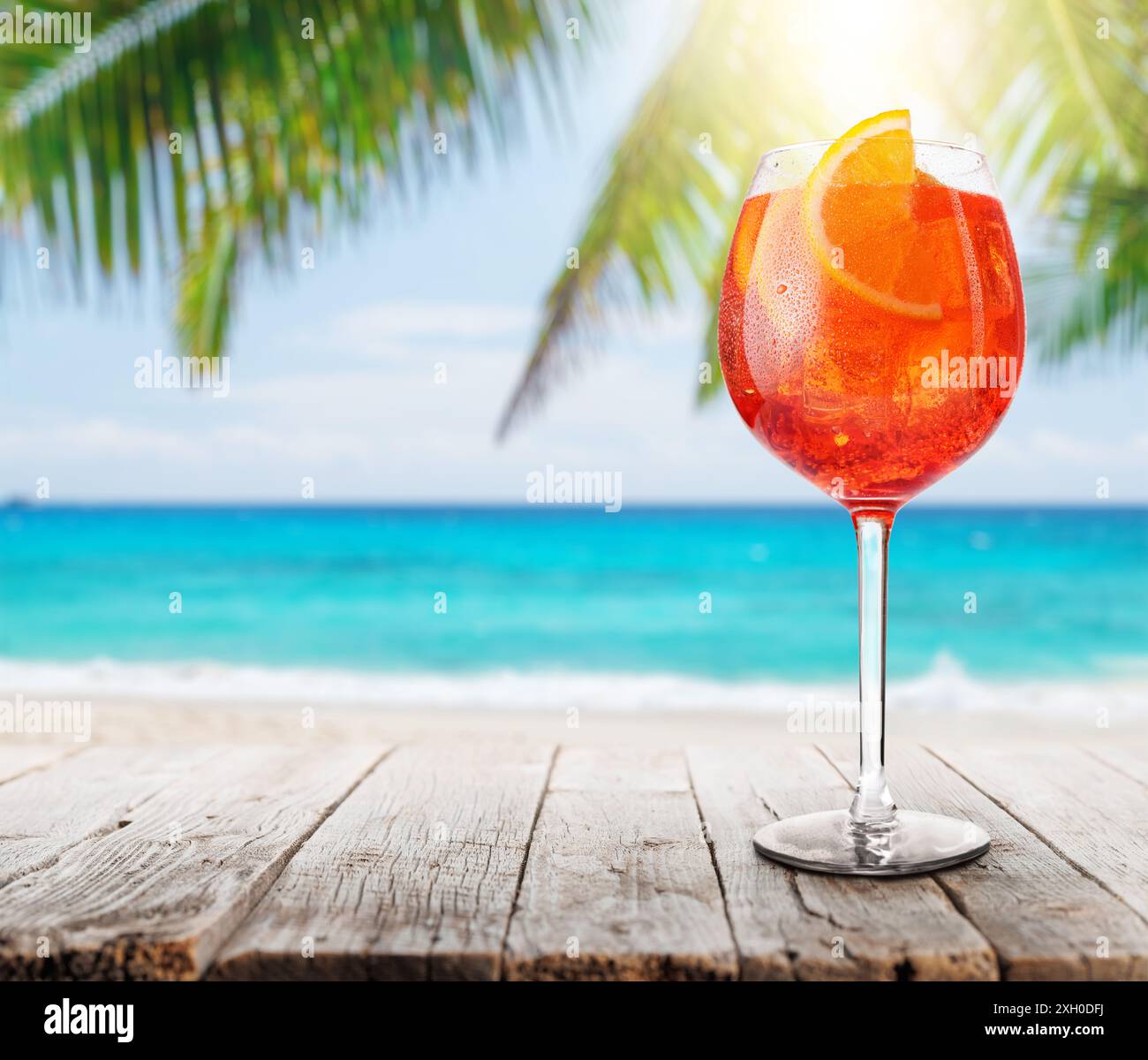 Glass of Aperol Spritz on a table with a stunning sea and beach ...