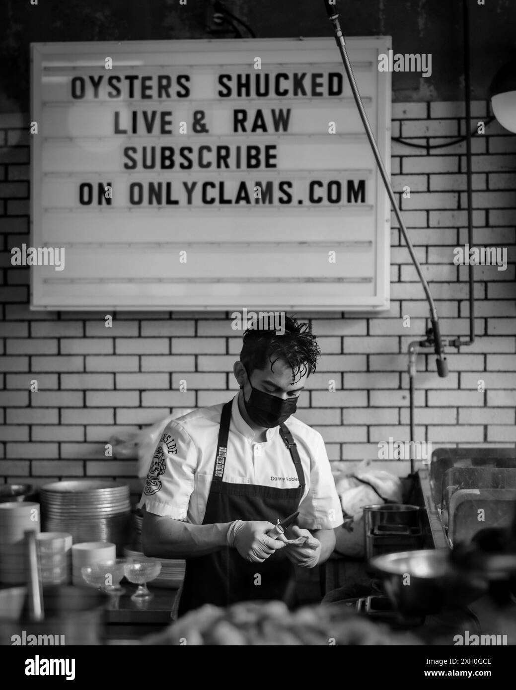 Shucking an oyster Black and White Stock Photos & Images - Alamy