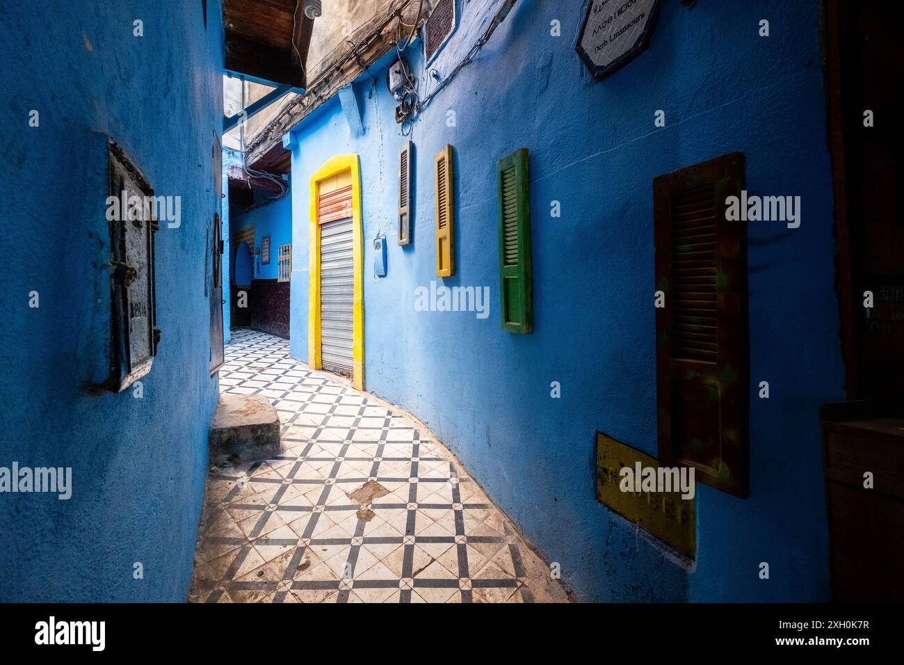 Daylight enters from above into a beautiful blue and multicolored alley ...