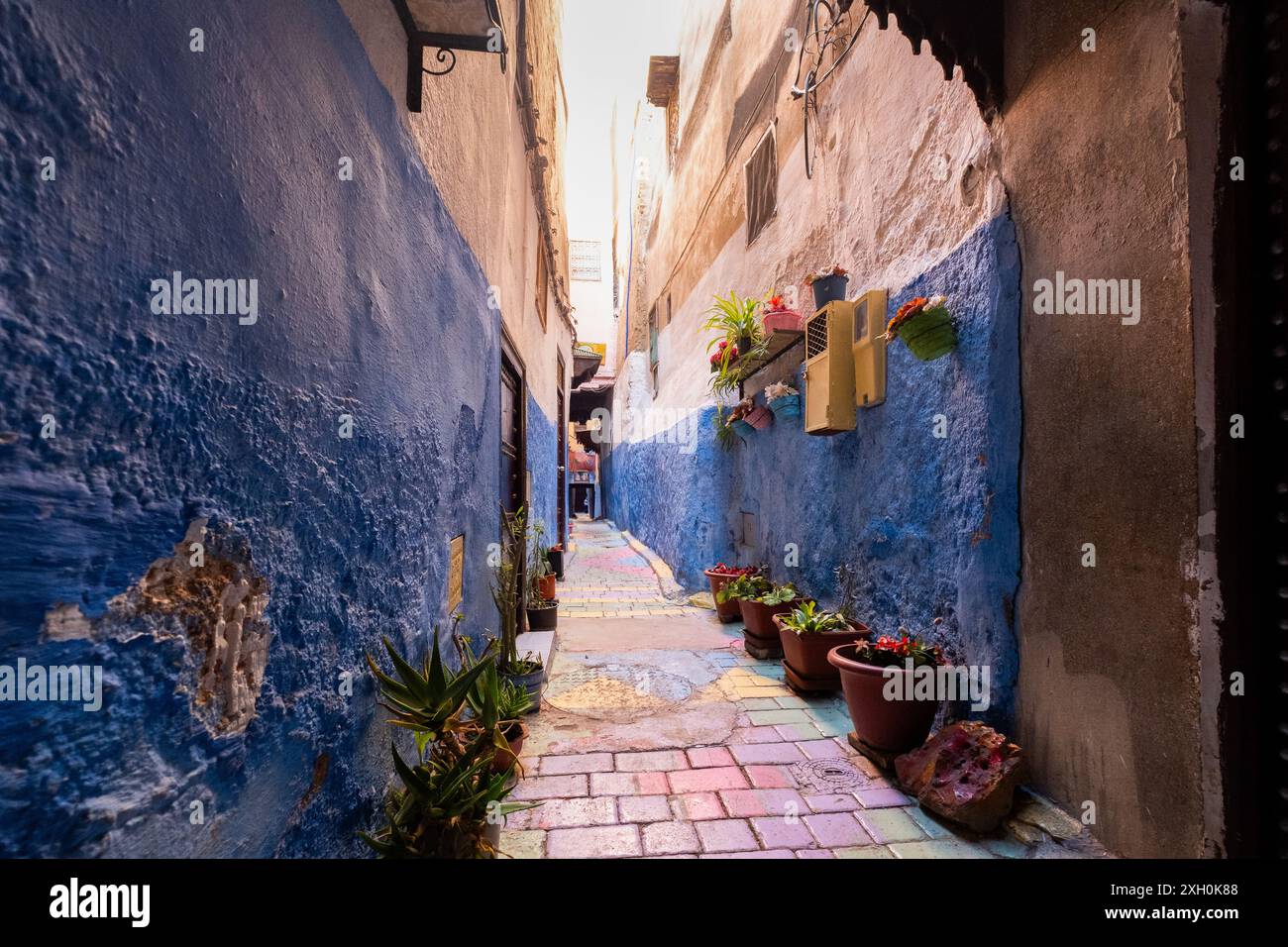 Daylight enters from above into a beautiful blue and multicolored alley ...