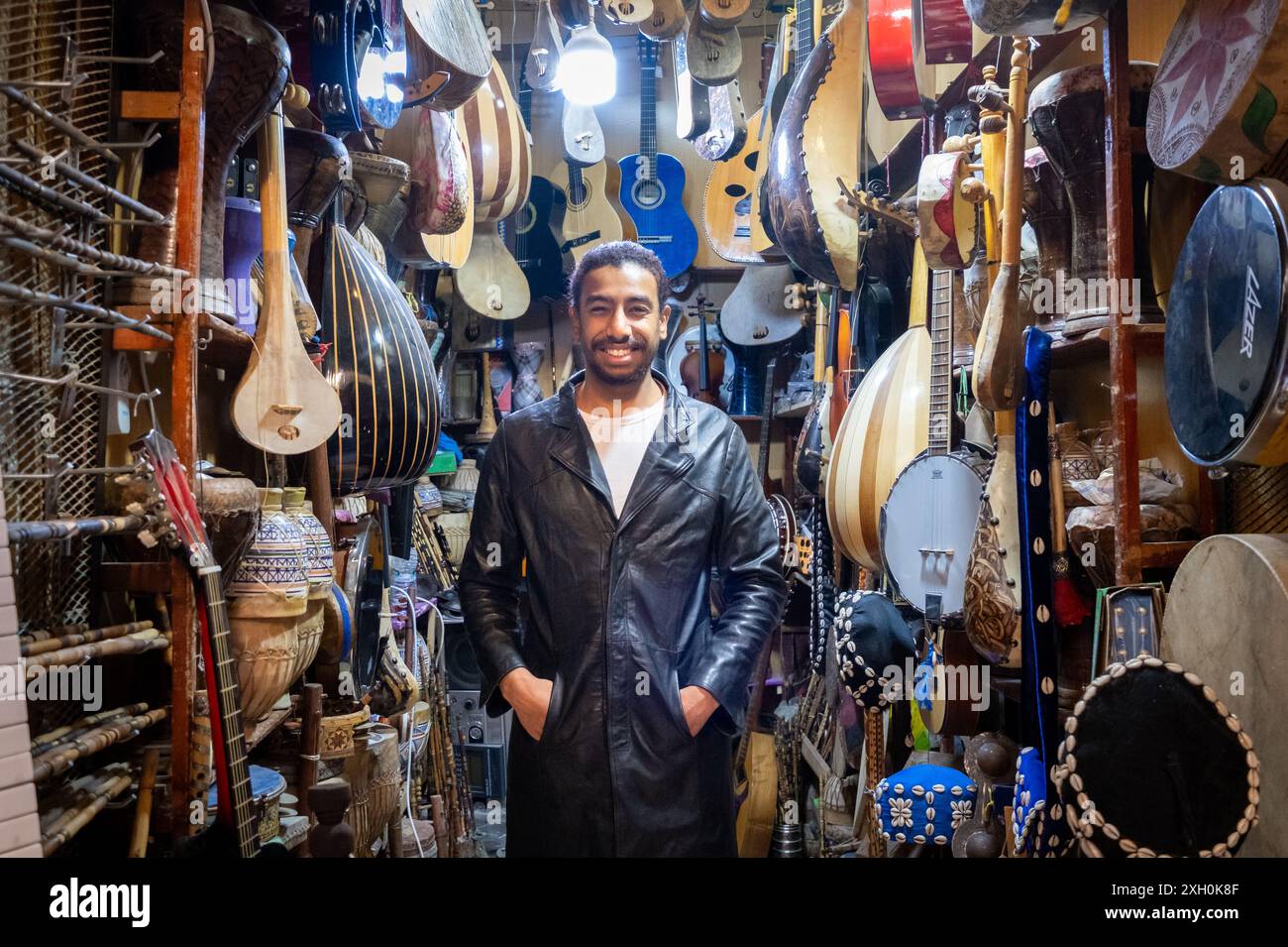 A seller in the medina market of Fez in Morocco, poses happily in front ...