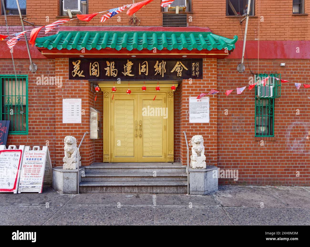 NYC Chinatown: Chinese flags and symbols surround gold-colored door to ...