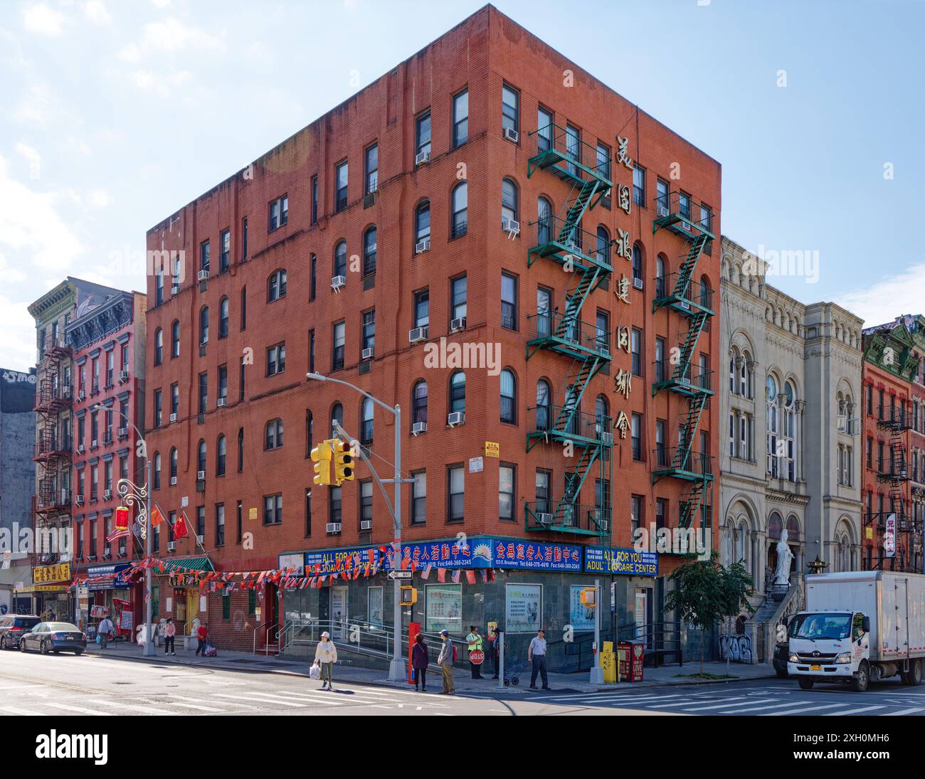 NYC Chinatown: A low-rise, plain, painted brick apartment building and ...