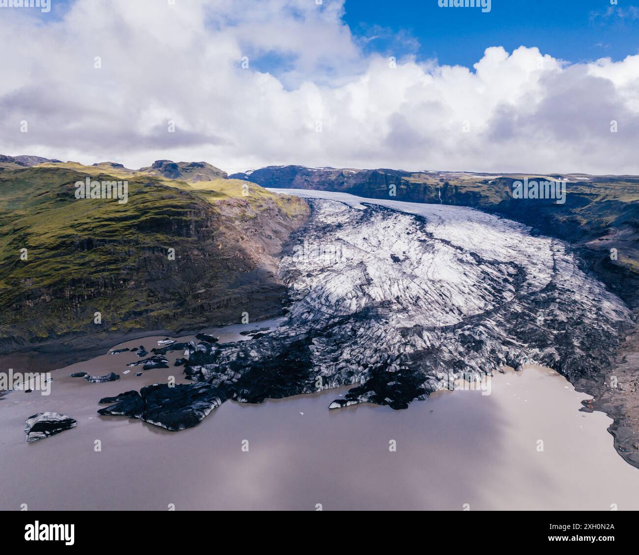 Aerial view of Sólheimajokull glacier in Iceland, featuring contrasting ...