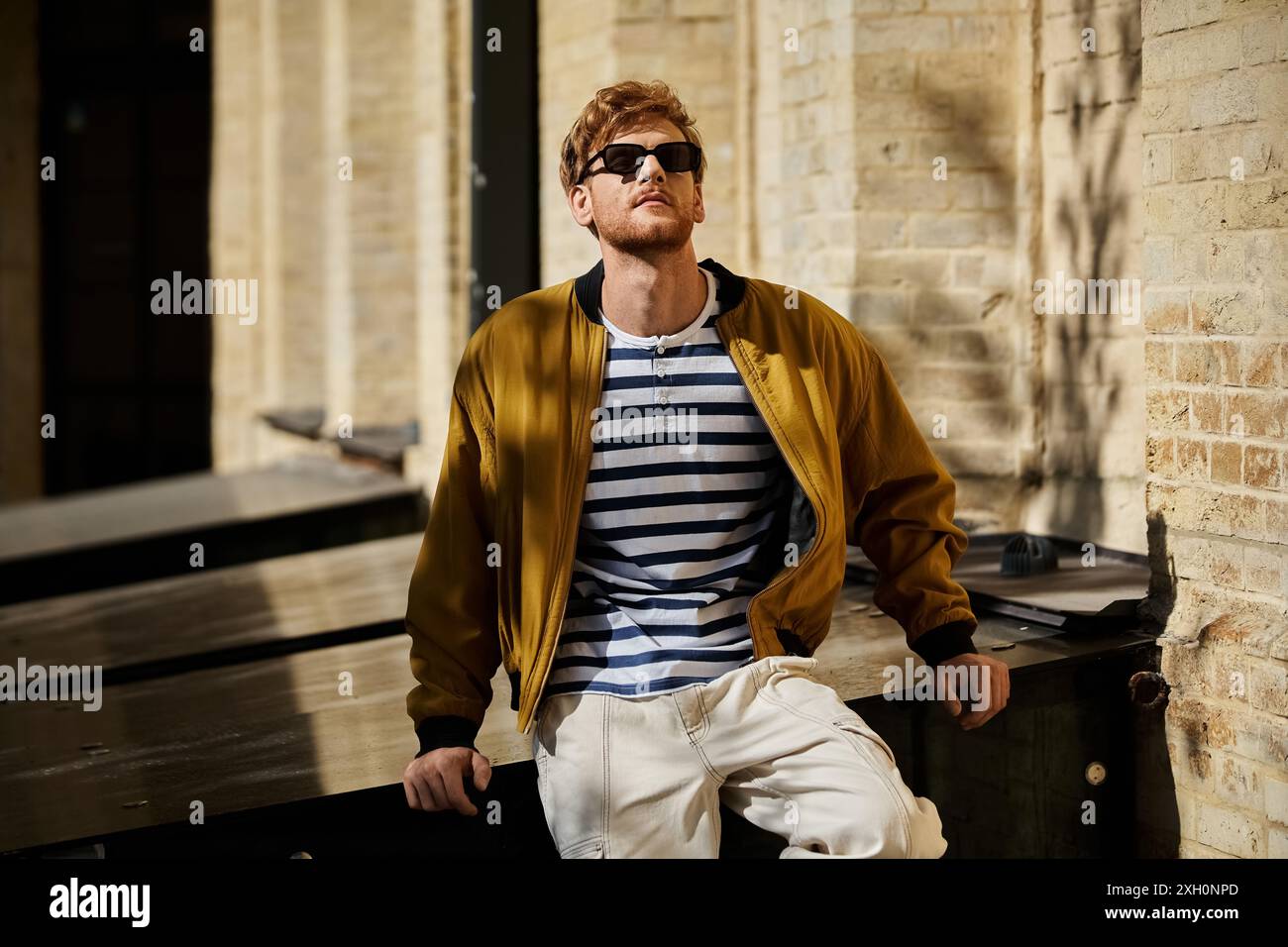 Red-haired man in debonair attire, posing in front of building Stock ...