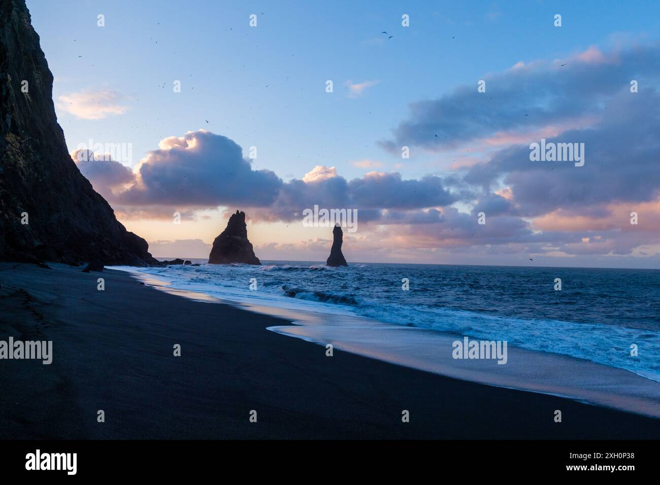 Sunrise view of Reynisfjara beach with its iconic sea stacks, located ...