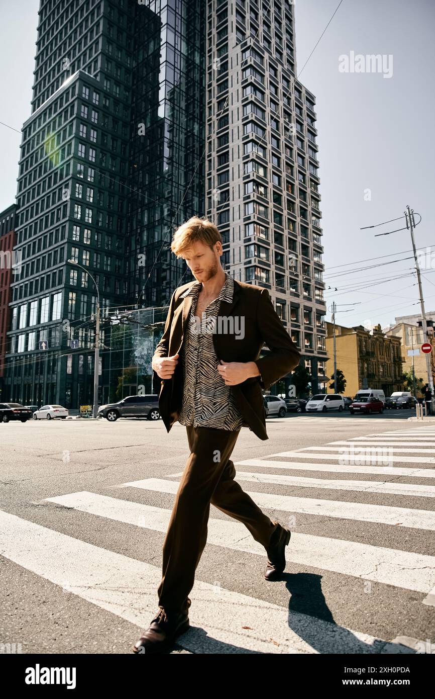 Young red-haired man in debonair attire walking across city street with ...