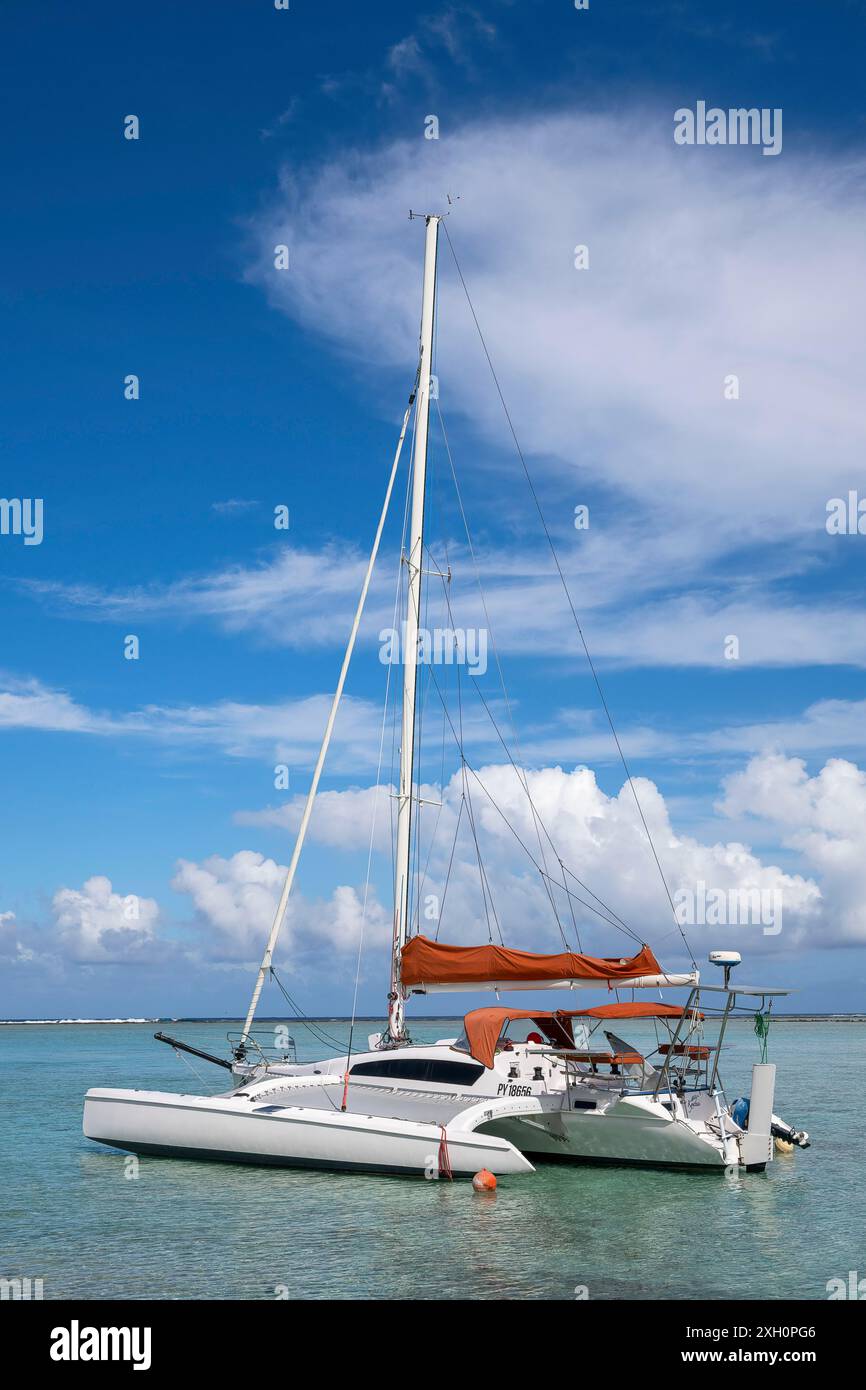 Catamaran and beautiful cloud formation, Tikehau, Atoll, Tuamotu ...