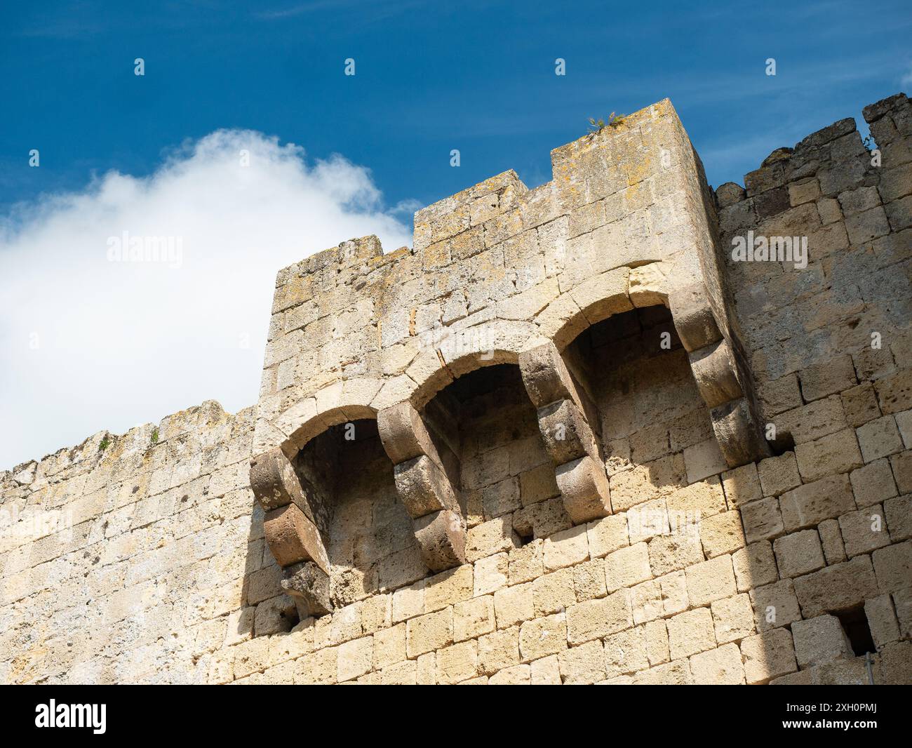 Medieval balcony on top of ancient weathered stone wall Stock Photo - Alamy