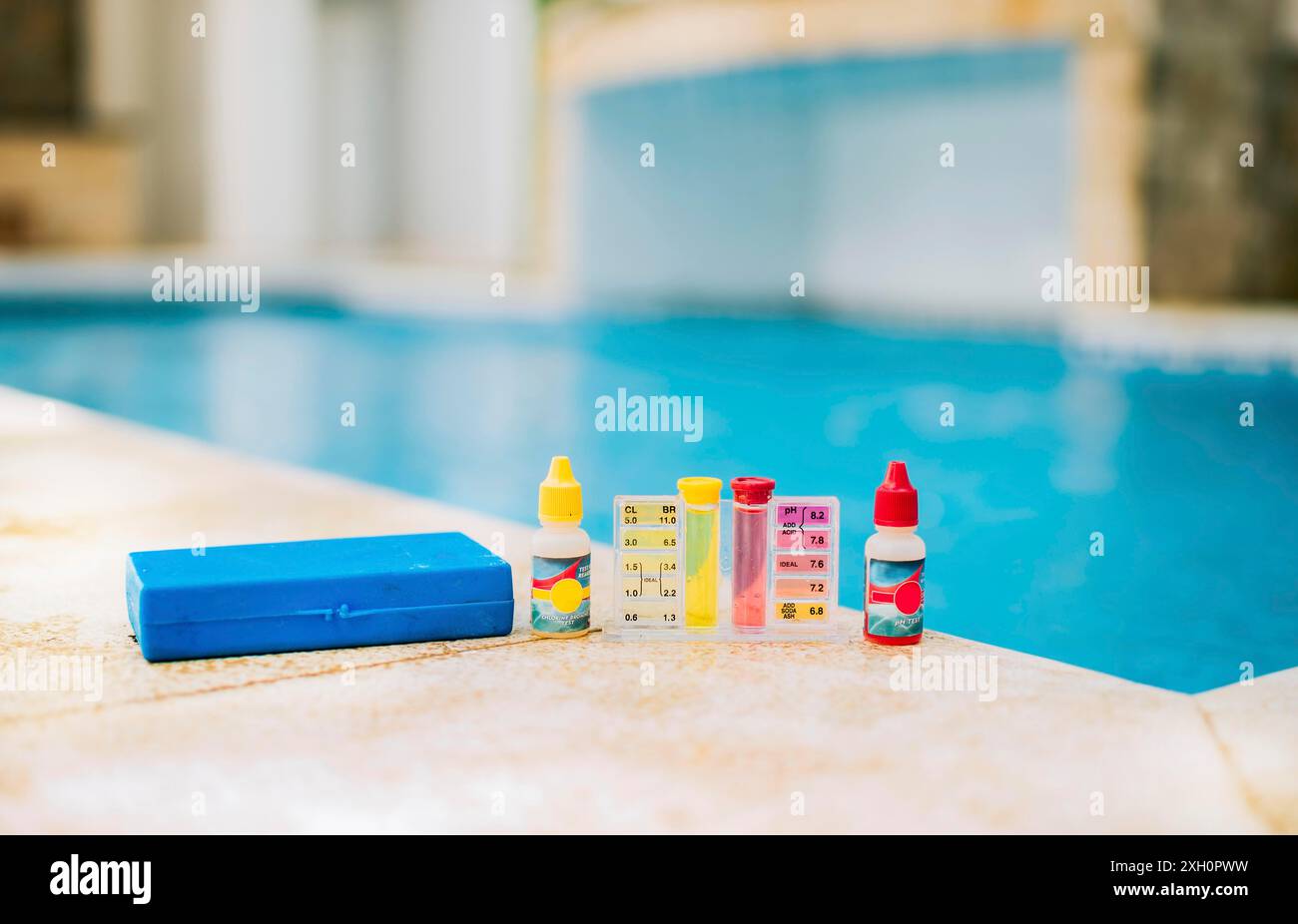 Water test kit on the edge of the swimming pool. Chlorine test kit for ...