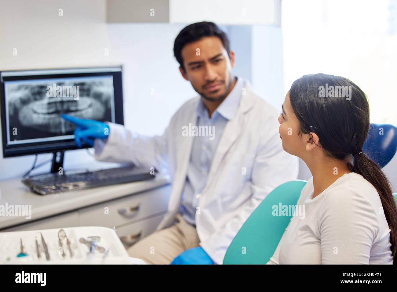 Dentist, consultation and x ray of teeth on computer for patient ...