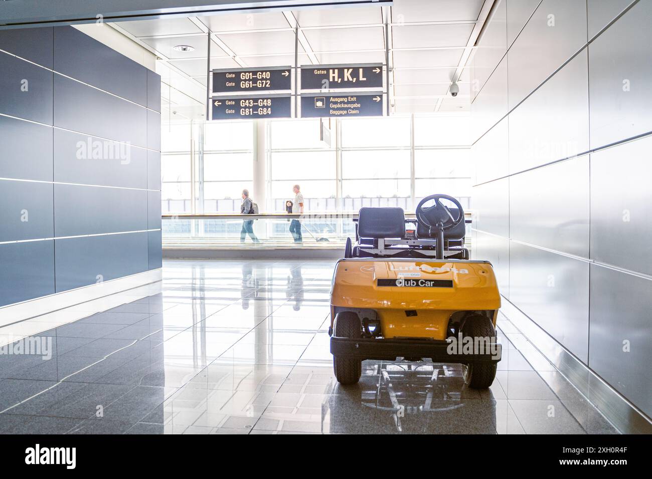 Passengers using a modern airport transportation vehicle in a terminal ...