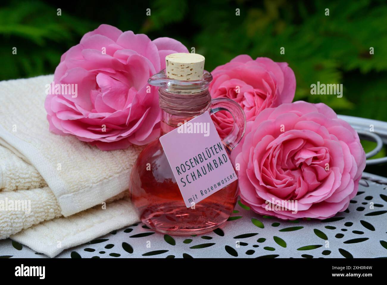 Rose blossom foam bath and rose blossoms, wellness Stock Photo - Alamy