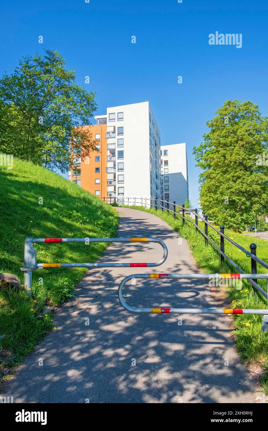Walkway with barriers to a high-rise building in a residential area in ...