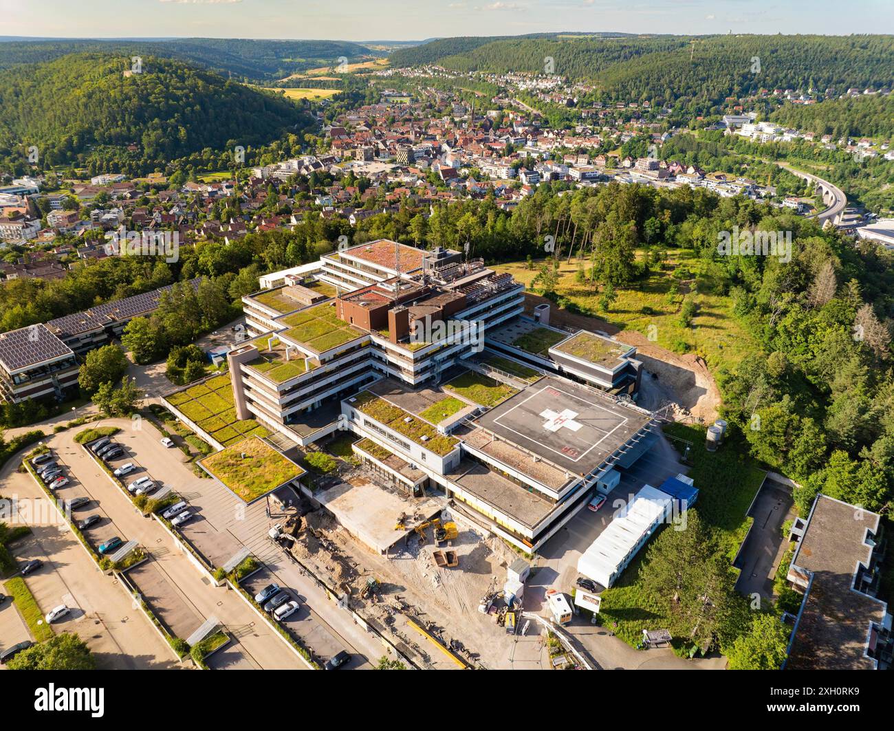 Aerial view of a large building complex with car parks, surrounded by ...