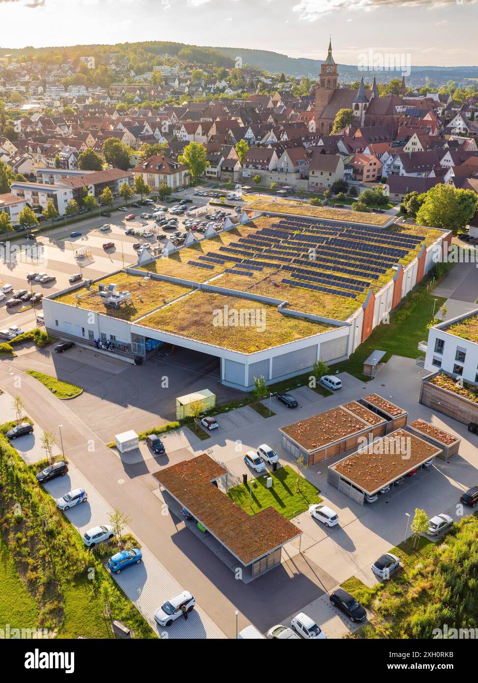 Aerial view of a town with a large building with solar panels installed ...