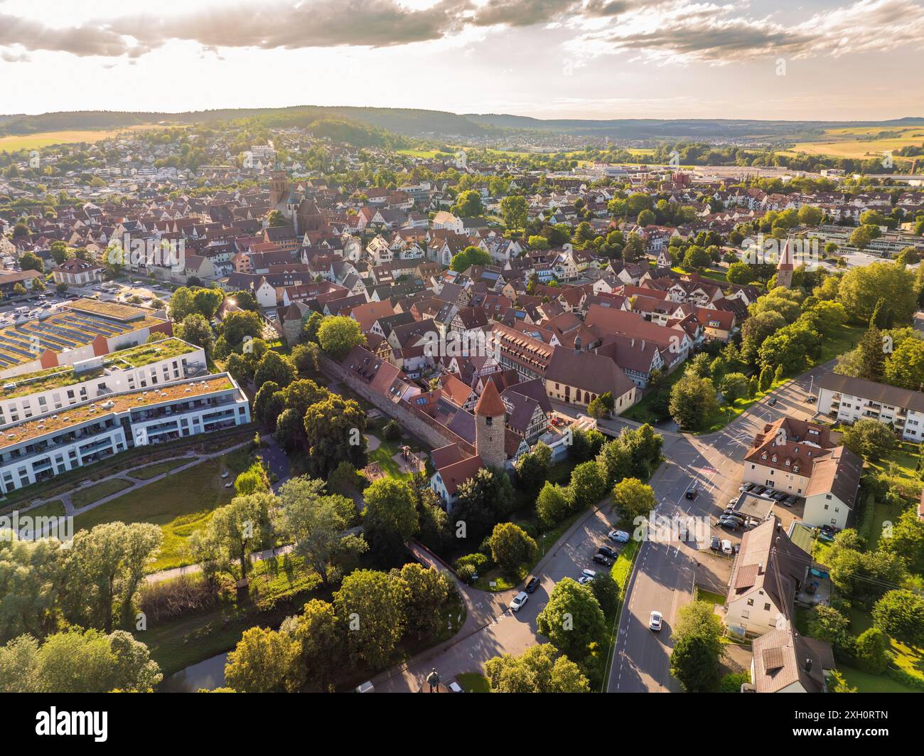 Aerial view of a busy city centre with red roofs and green trees in the ...