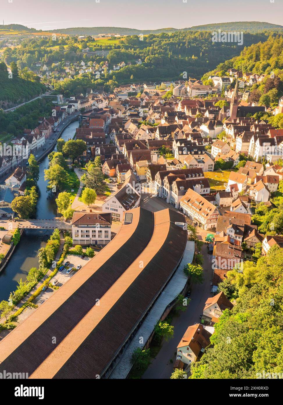 Aerial view of a town with many roofs and a river and bridge ...