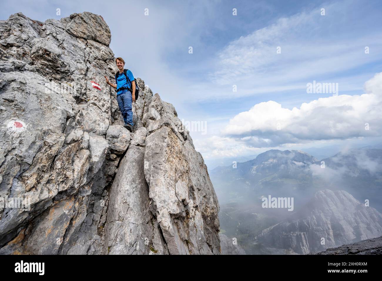 Mountaineer climbing on the rock, on a narrow rocky ridge, Watzmann ...