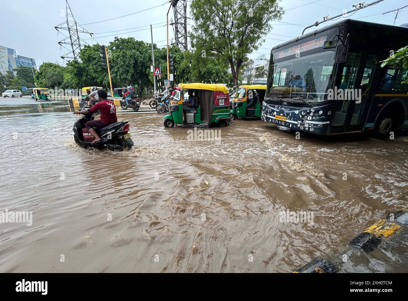 GURUGRAM, INDIA - JULY 9: Vehicles wade through a waterlogged stretch after the rain at sector ...