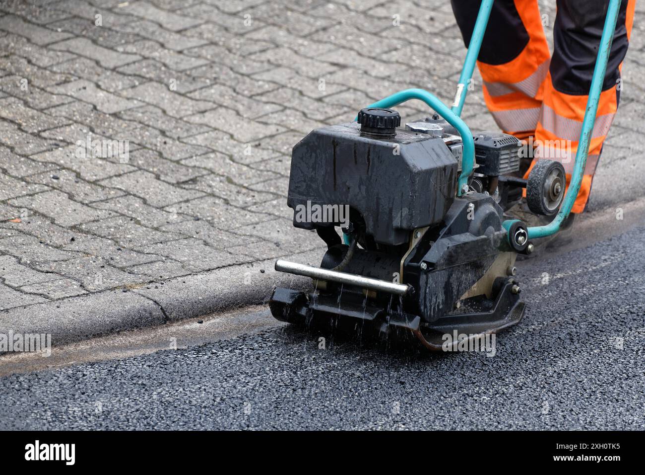Asphalt paver with vibratory plate Stock Photo - Alamy