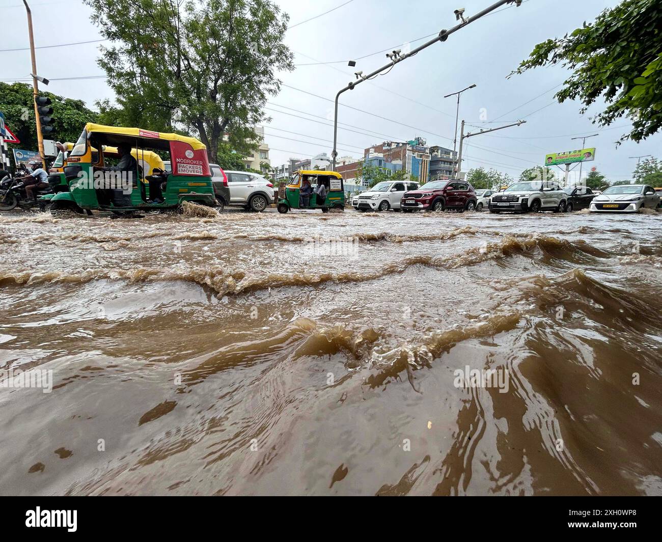 GURUGRAM, INDIA - JULY 9: Vehicles wade through a waterlogged stretch after the rain at sector ...