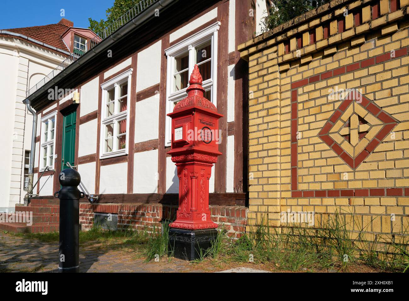 Historic fire alarm in front of an old half-timbered house in the ...