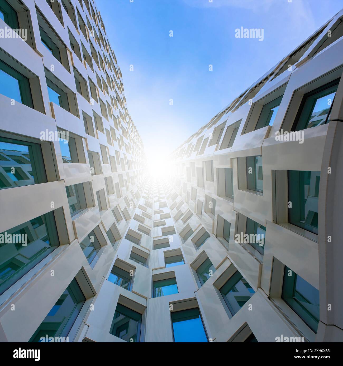 High-rise building in the city centre of Berlin with blinding sun in ...