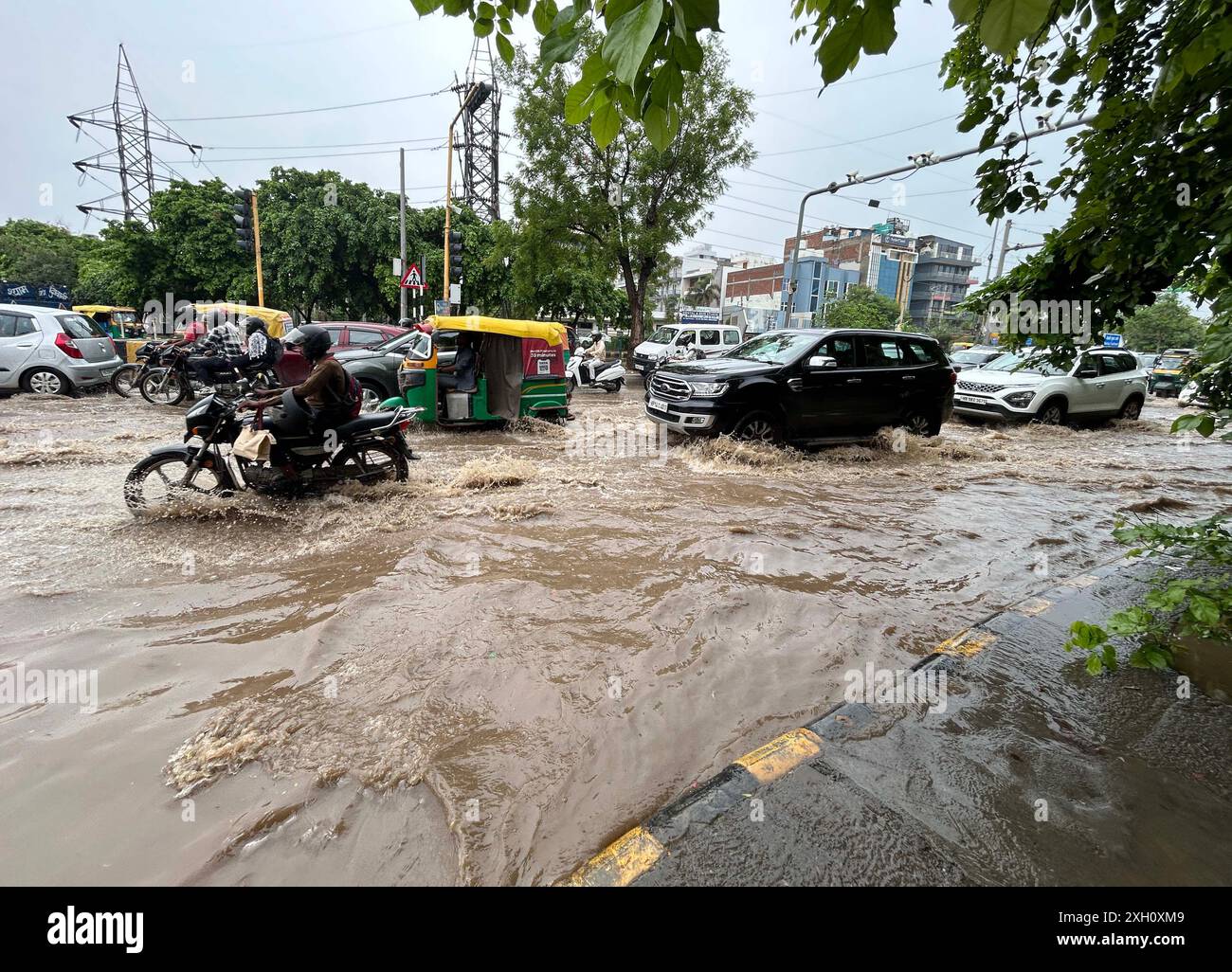 GURUGRAM, INDIA - JULY 9: Vehicles wade through a waterlogged stretch after the rain at sector ...