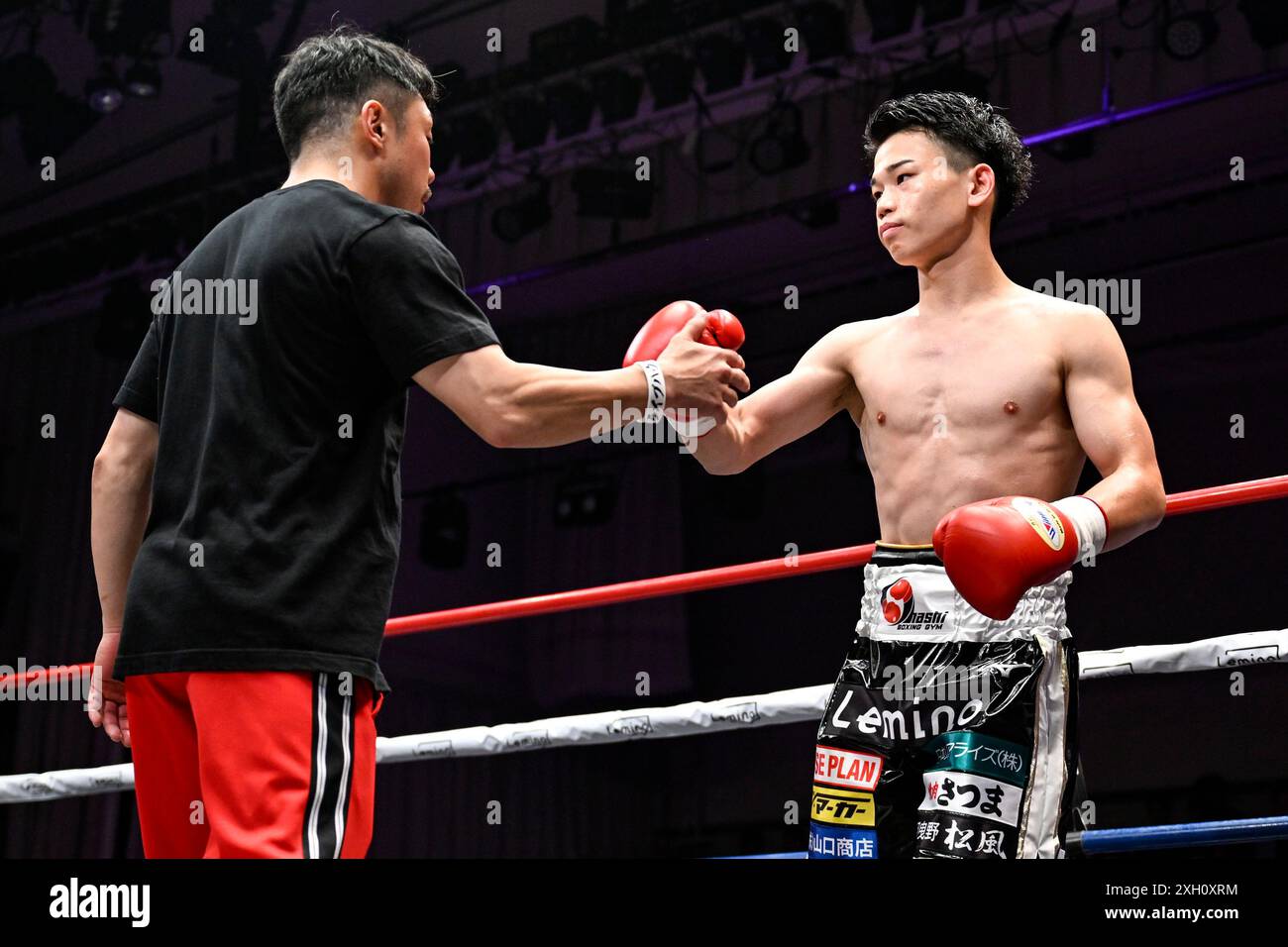 Japan's Shogo Tanaka, right, gets a five from trainer Akira Yaegashi before his pro debut's 6R ...