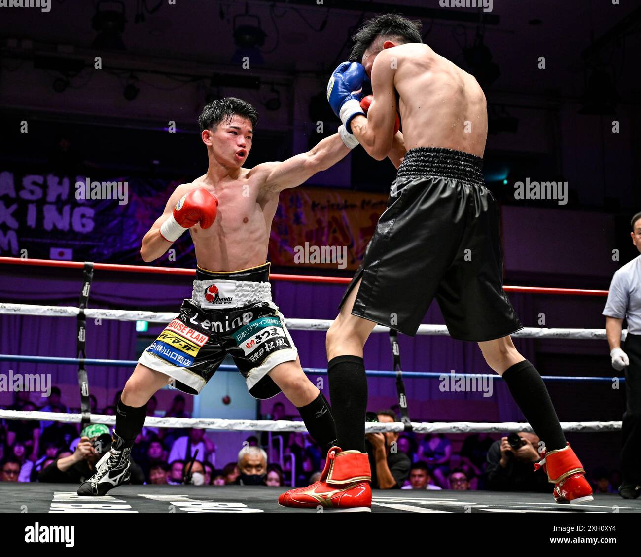 Shogo Tanaka (red gloves) throws a left at Ryunosuke Takaguma (blue ...