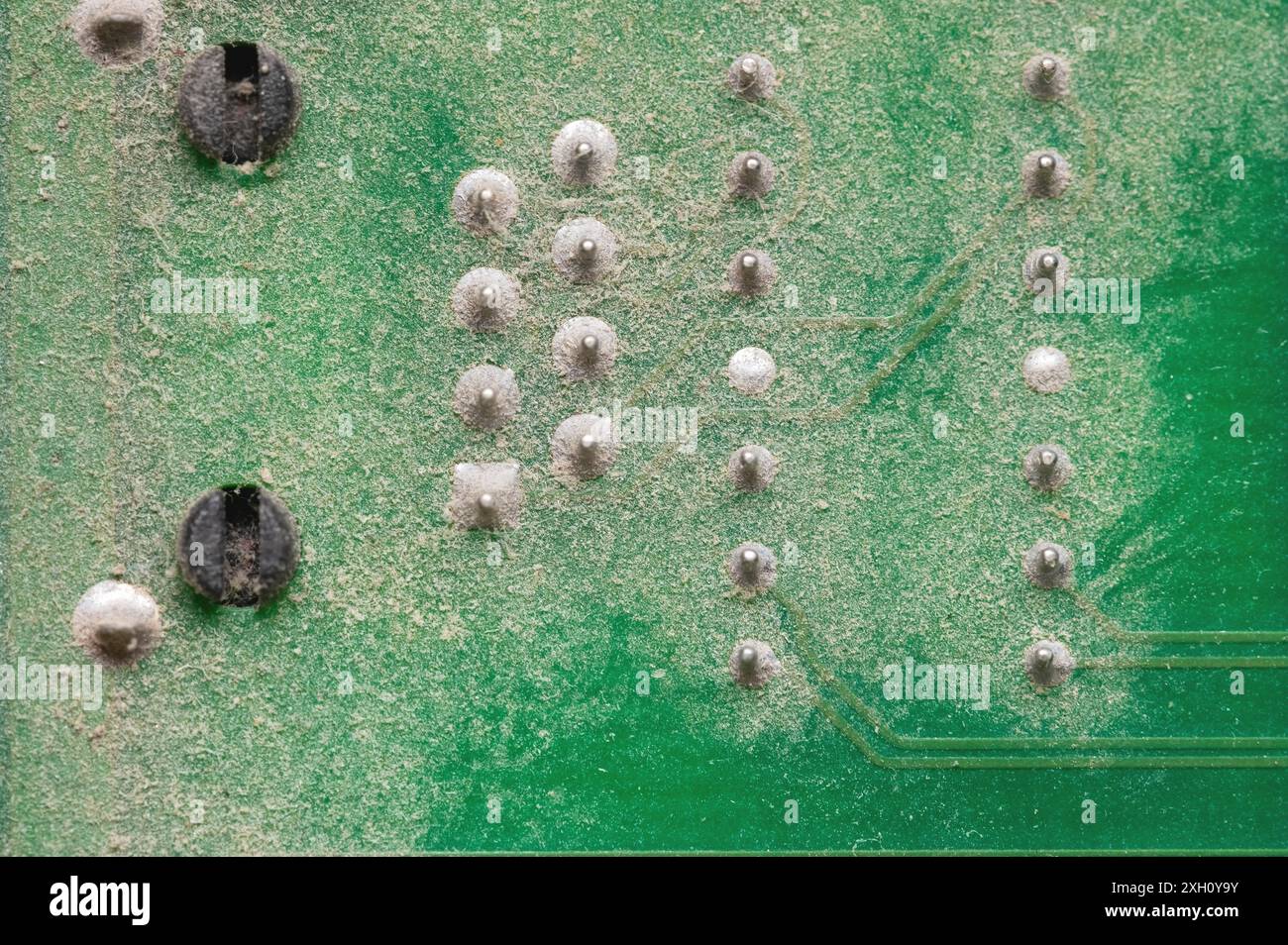 Electronic components close-up on an old computer motherboard. Dust on ...
