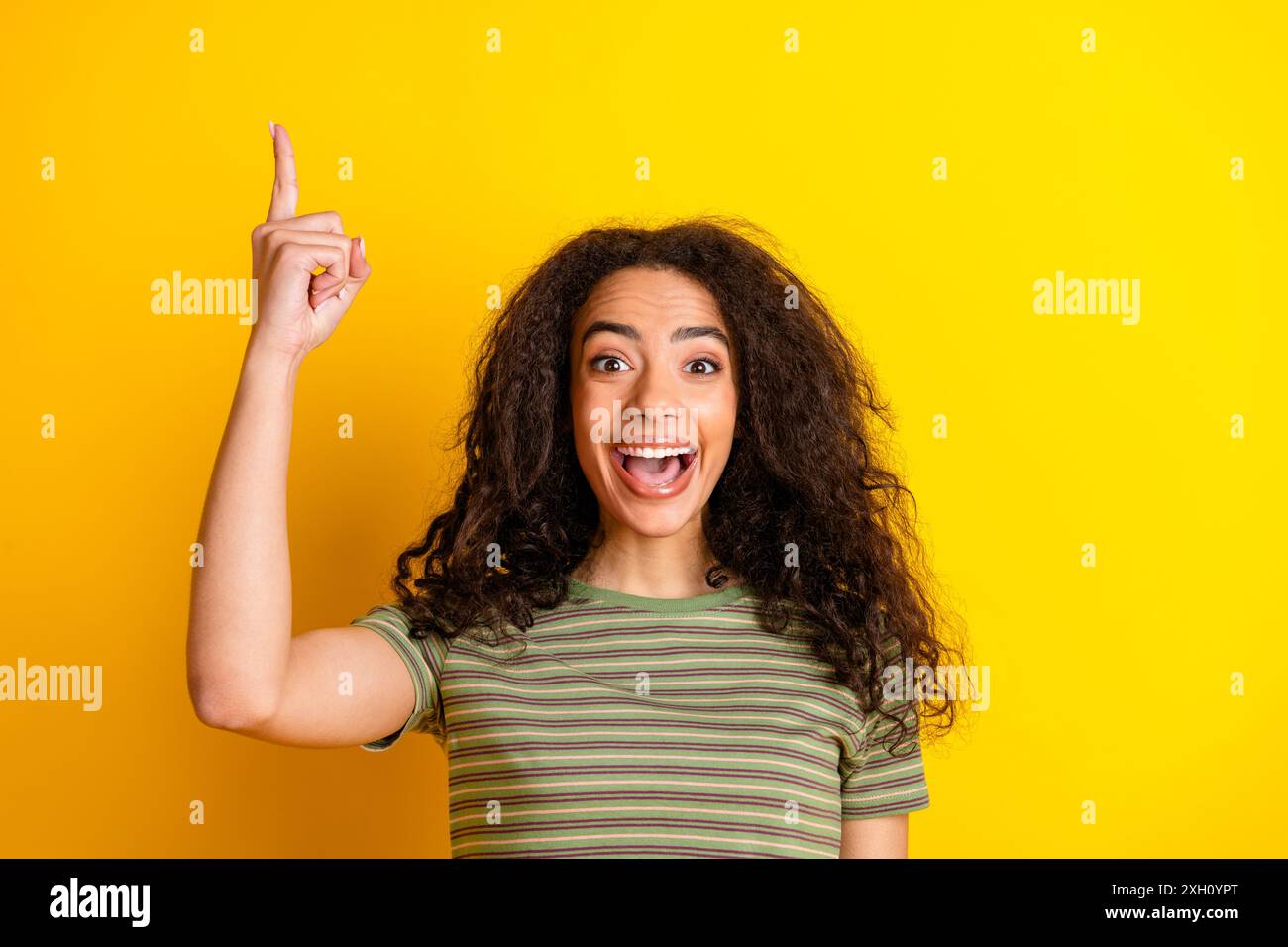 Photo of smart excited girl with wavy hairstyle dressed striped t-shirt ...